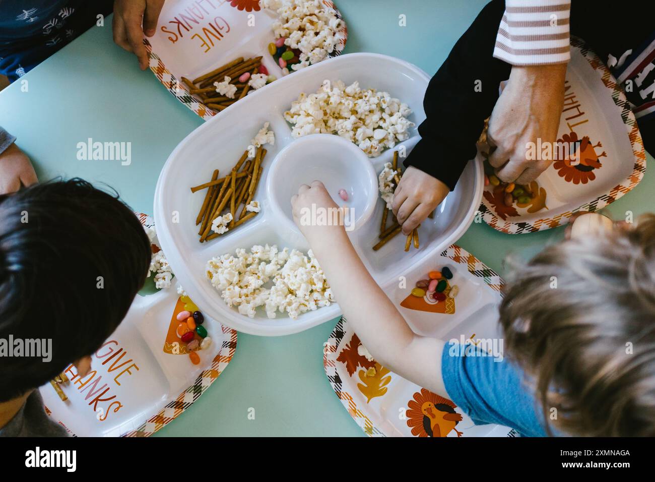 Kids eat Thanksgiving snacks together from above at home Stock Photo ...