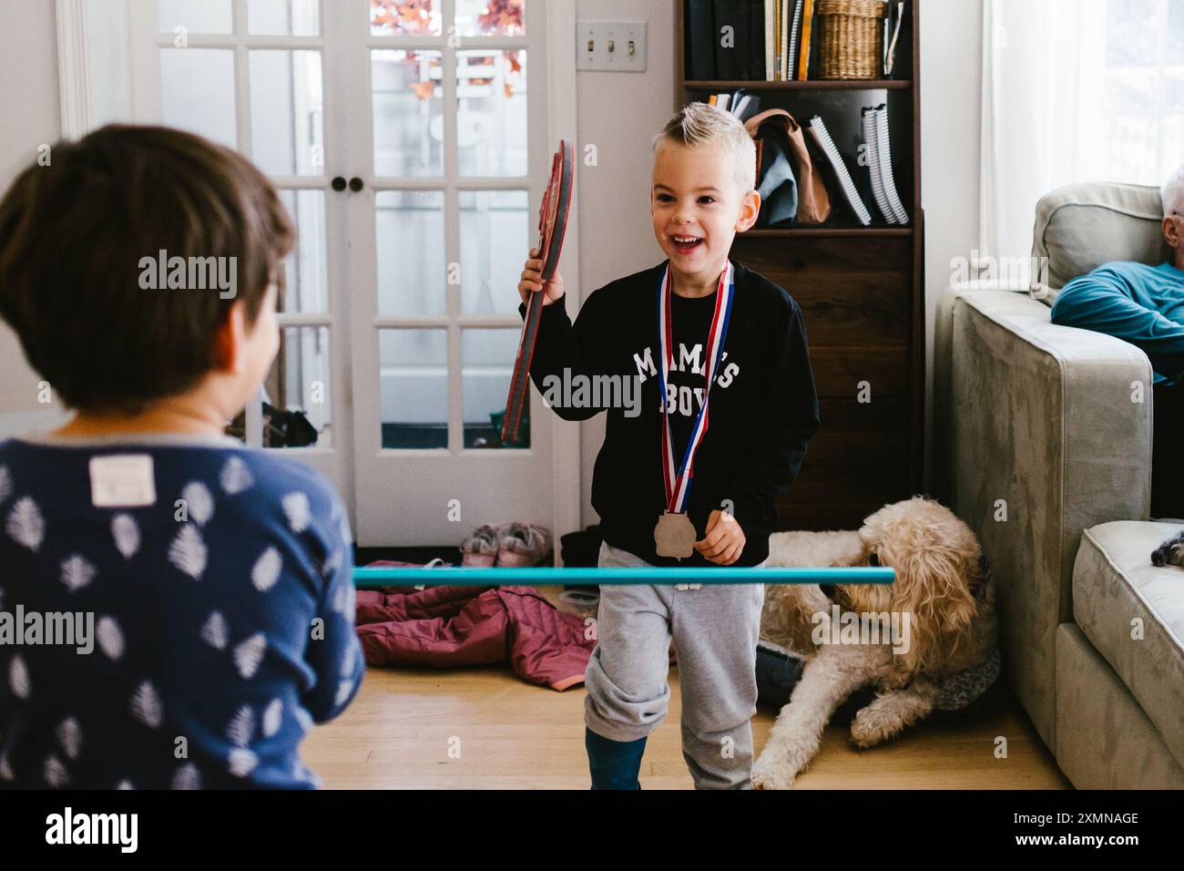 Cousins play together at home with household goods around Stock Photo ...