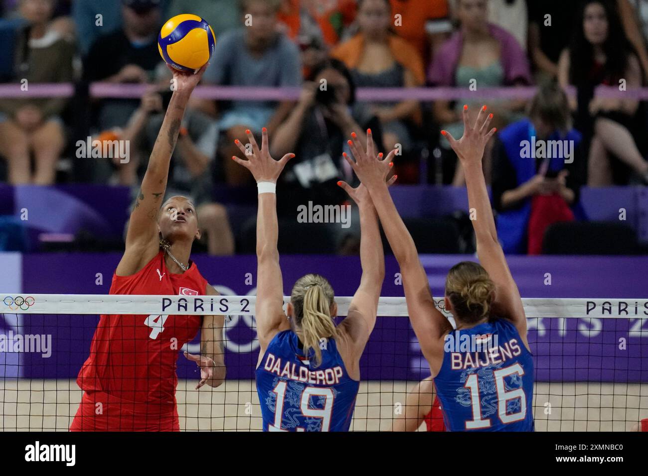 Melissa Vargas of Turkey, left, spikes the ball against the Netherlands ...