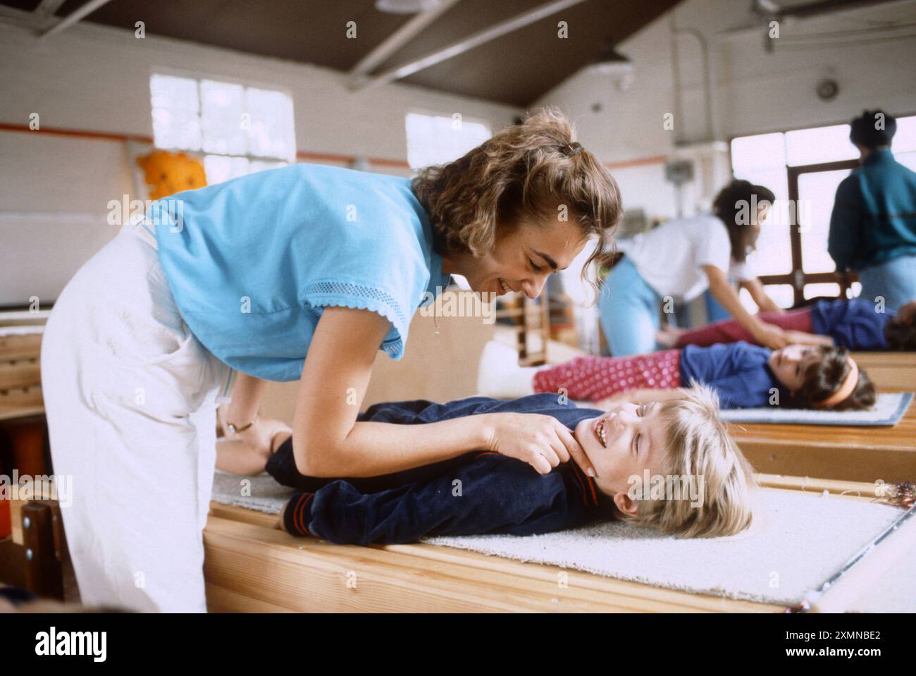 A carer and a patient at cerebral palsy therapy centre The Rainbow ...