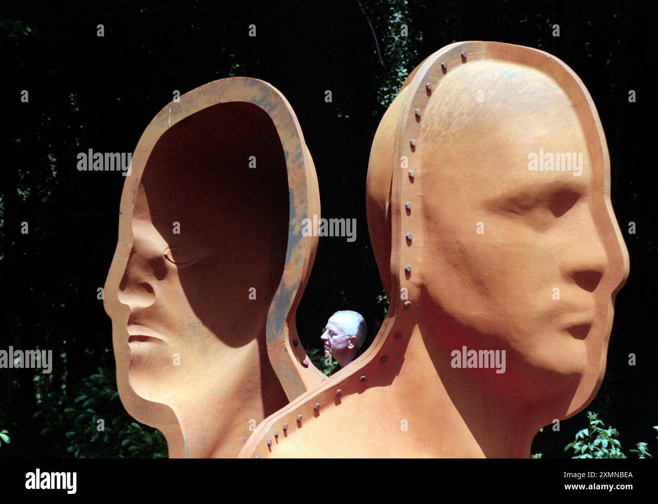 Janus Head sculpture by Peter Burke Sculptor Peter Burke stands dwarfed ...