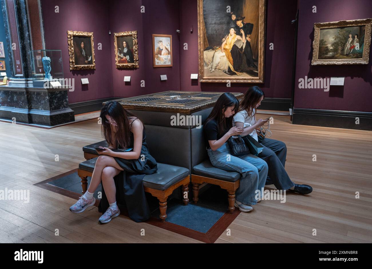 Fitzwilliam Museum Art gallery Cambridge UK Visitors on their mobile phones in the art gallery ...