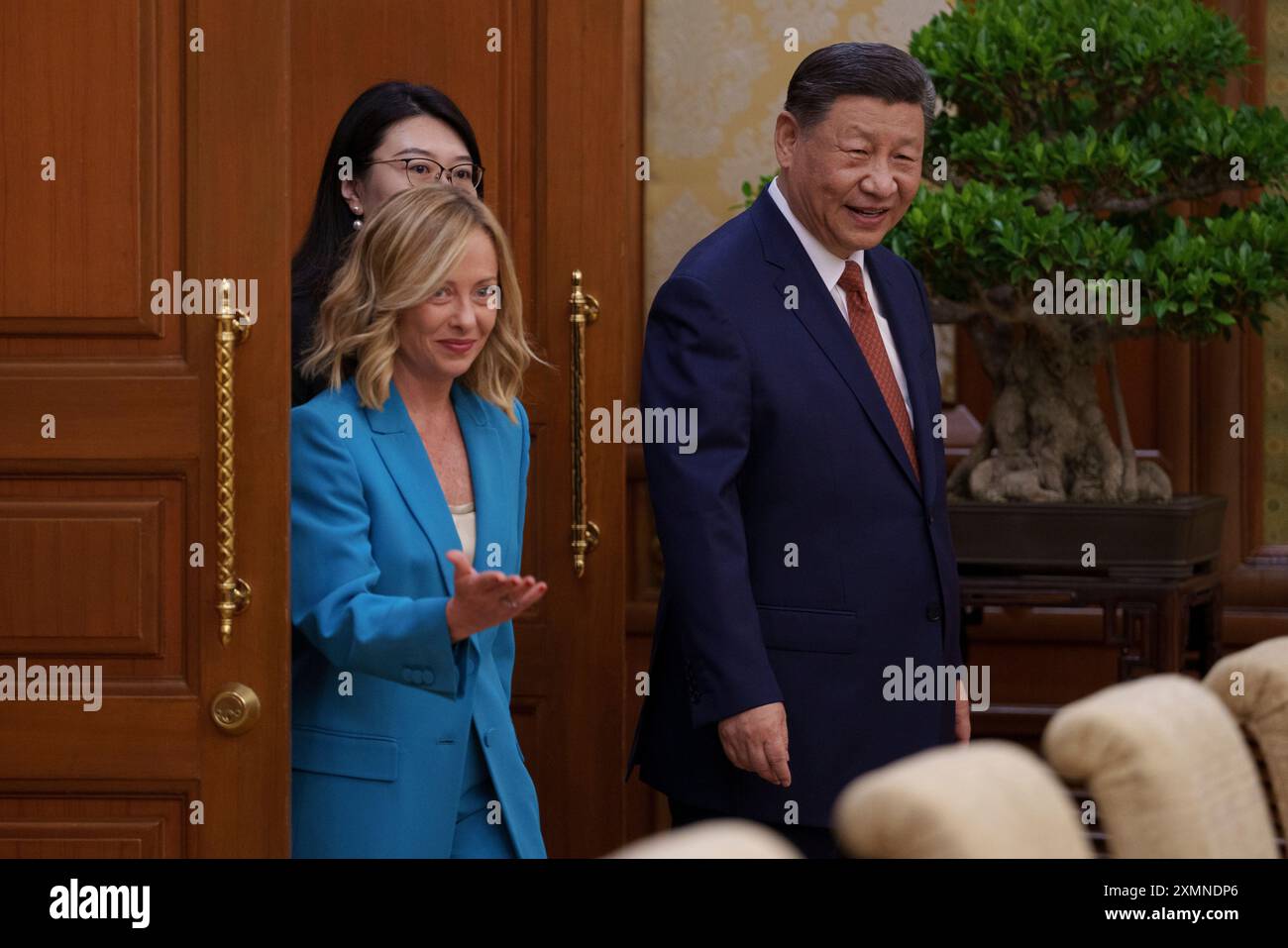 Chinese President Xi Jinping, right, walks with Italian Premier Giorgia ...