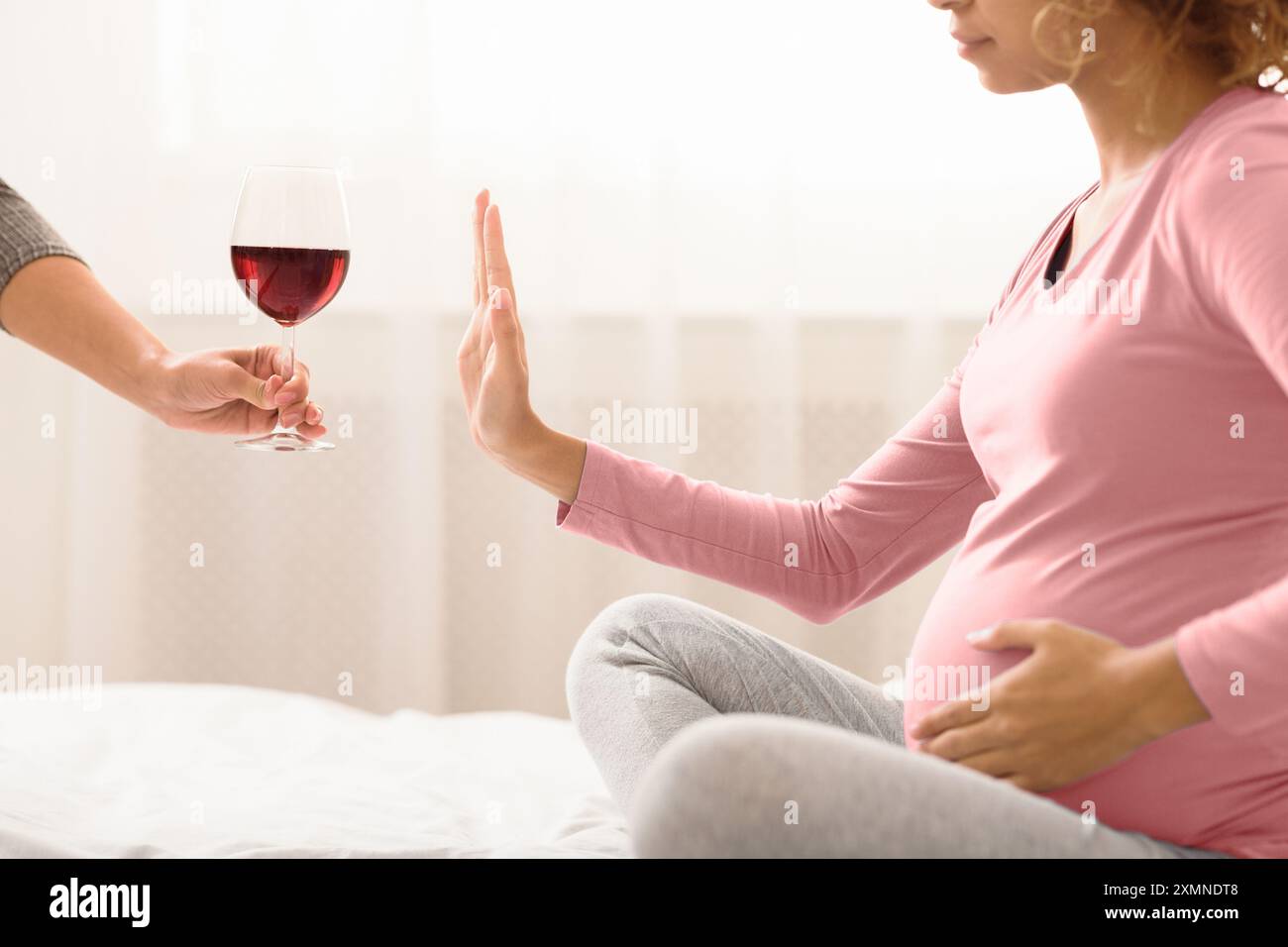 Alcohol prohibited. Expectant woman refusing to drink wine Stock Photo ...