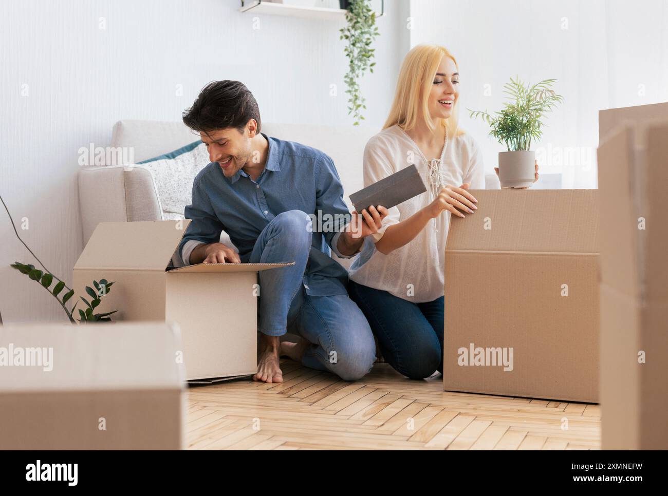 Woman unpacking moving boxes hi-res stock photography and images - Alamy