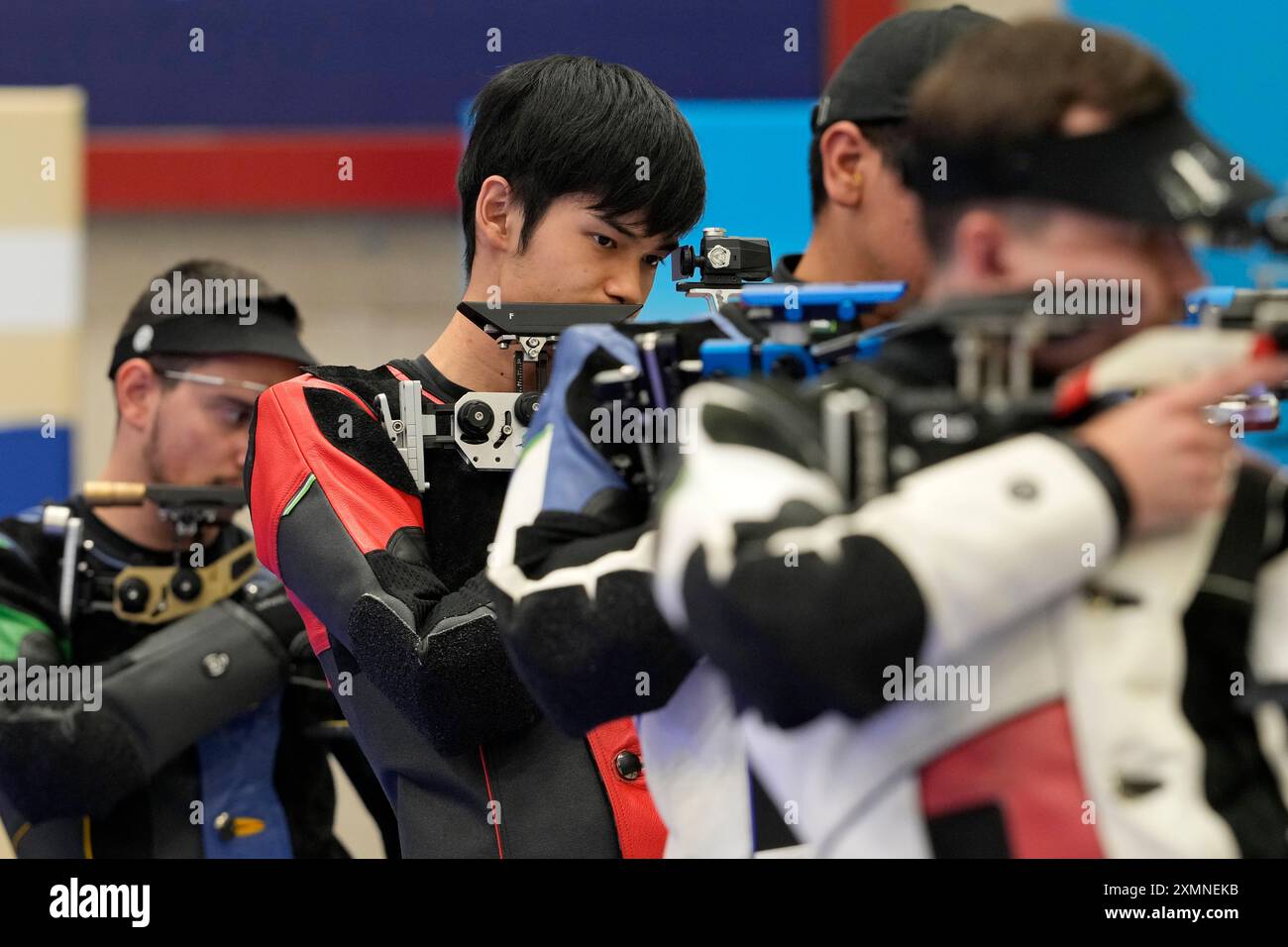 China's Sheng Lihao, second left, competes in the 10m air rifle men's ...
