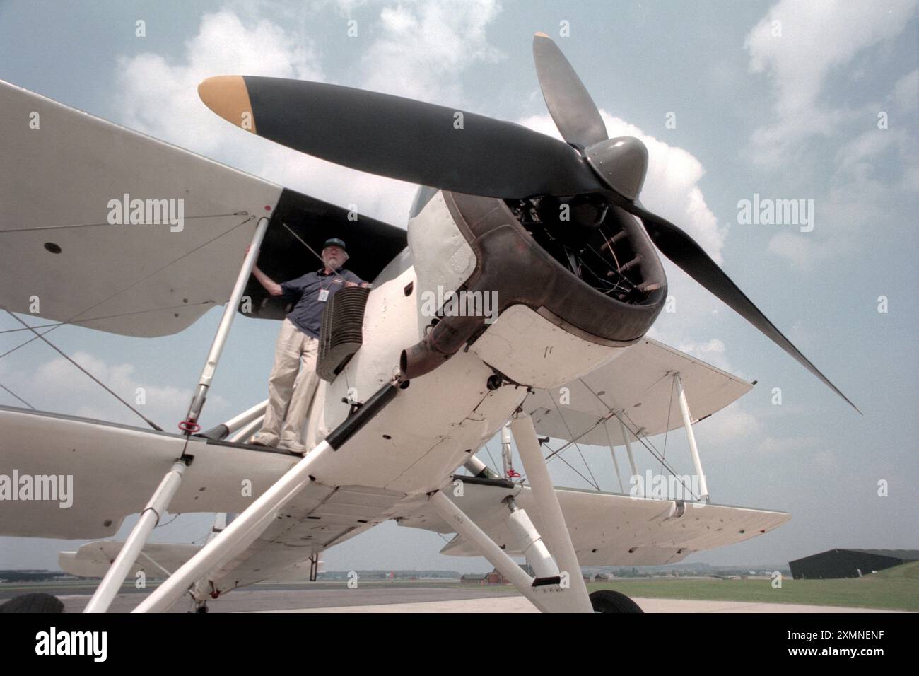 Former pilot John Tupper stands on the wing of his Swordfish biplane ...