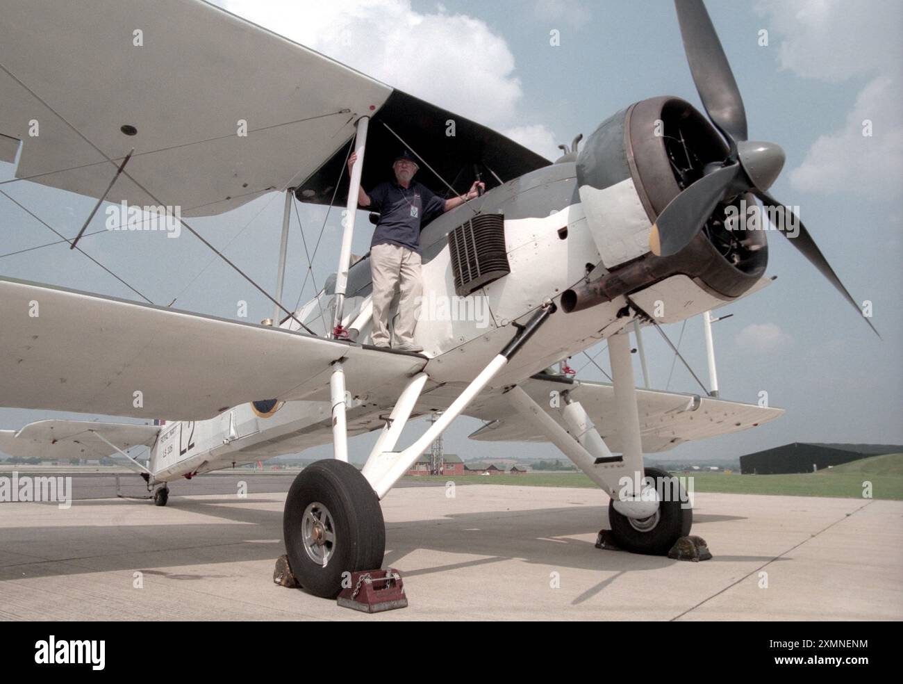 Former pilot John Tupper stands on the wing of his Swordfish biplane ...