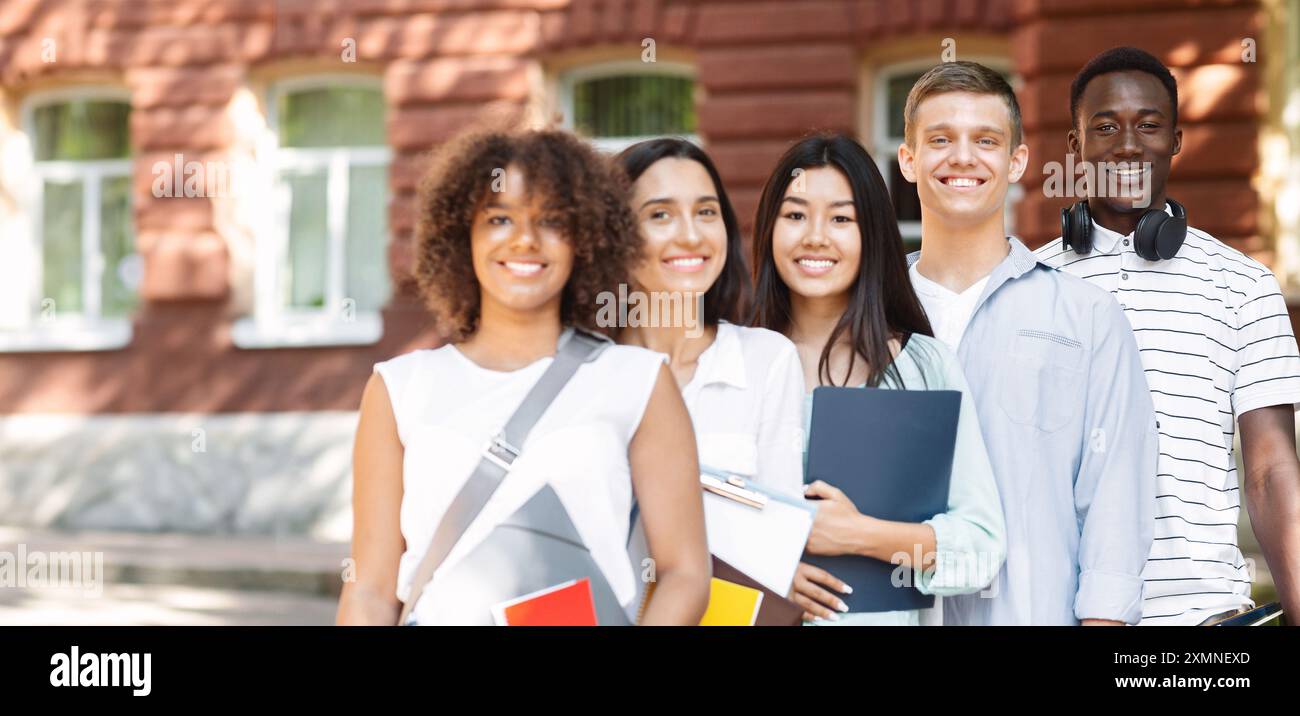 Group of smiling multicultural students posing near university campus ...