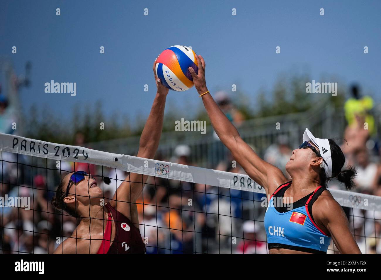 Canada's Sophie Bukovec, left, and China's Xia Xinyi compete in the ...