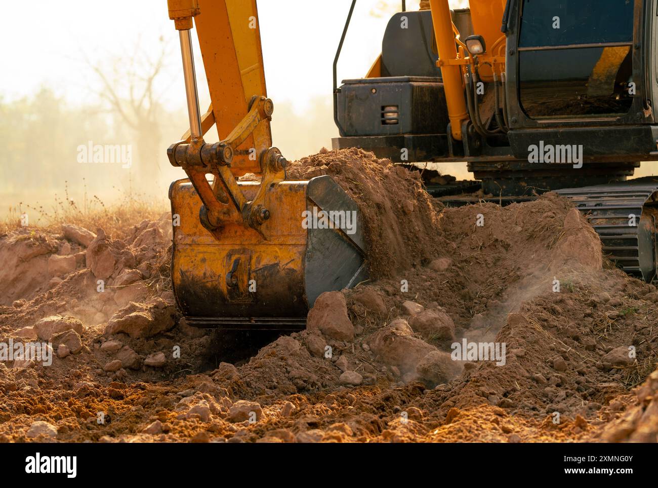 Backhoe working by digging soil at construction site. Crawler excavator ...