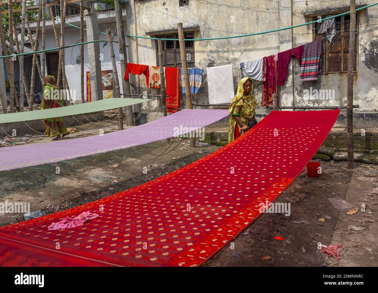 Bangladeshi workers putting wax on fabric, Dhaka Division, Rupganj ...