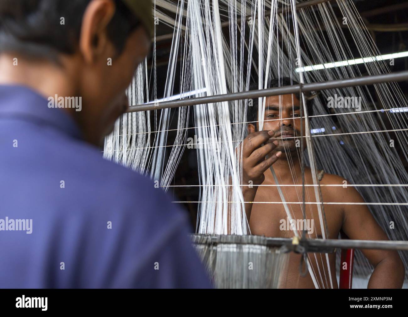 Bangladeshi men working on a textile factory looms, Dhaka Division ...