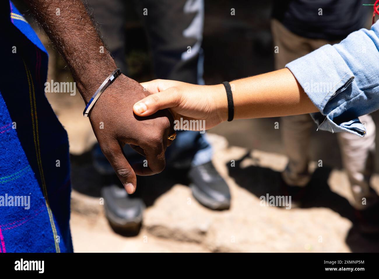 Multi Ethnic Young Female and Male Joining Hold of Hand Close-up Stock Photo - Alamy