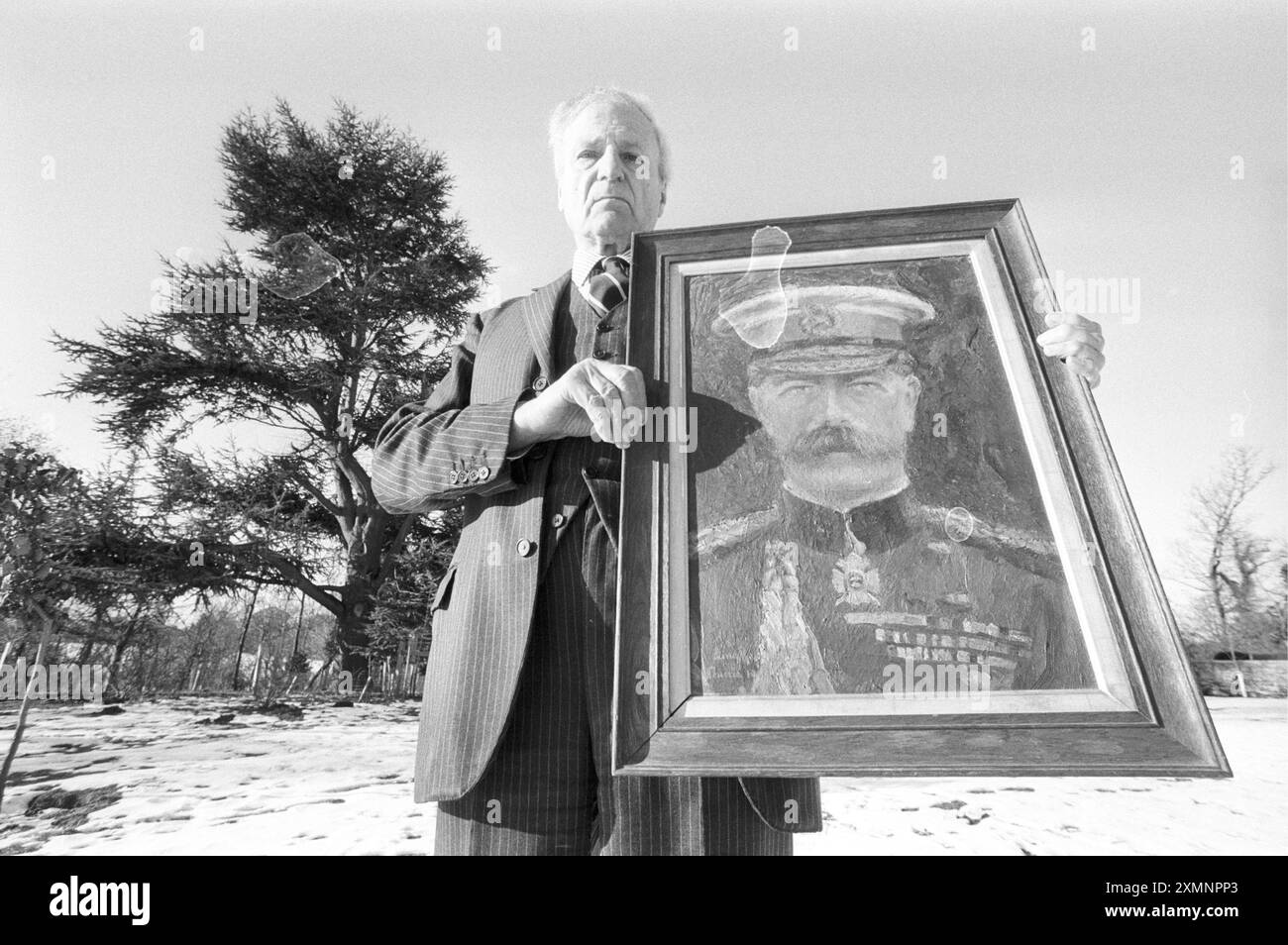 Third Earl Kitchener holding a portrait of his grandfather Lord ...