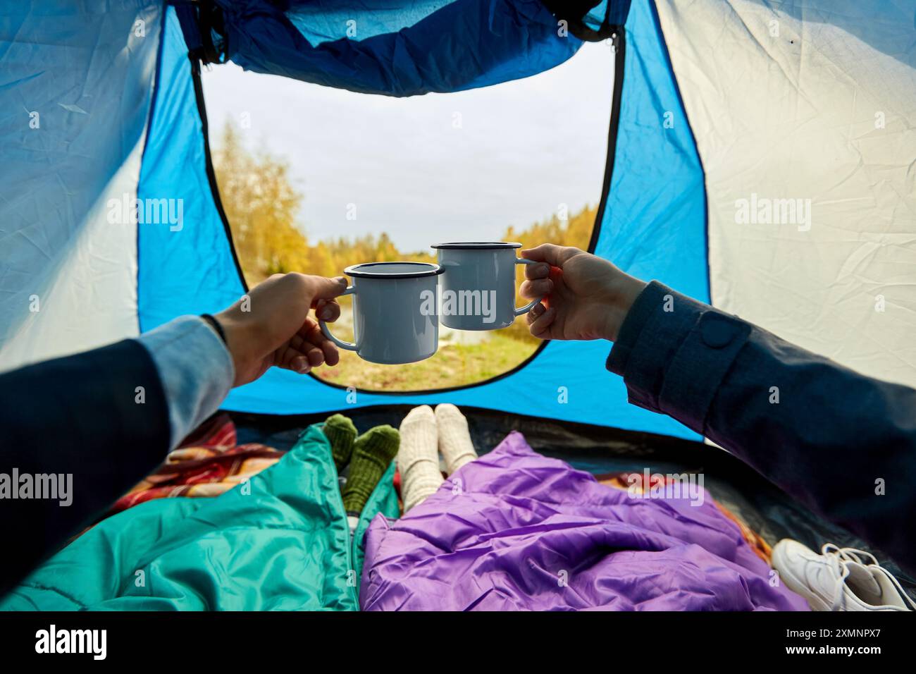 view from camp tent with hands toasting tea cups Stock Photo - Alamy