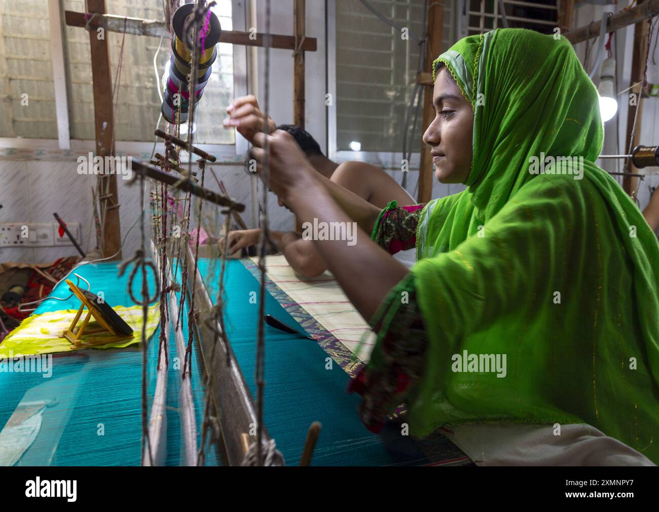 Bangladeshi woman weaving in a sari factory, Dhaka Division, Rupganj ...
