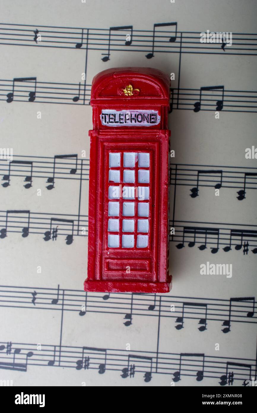 Telephone booth is placed on paper with musical notes Stock Photo - Alamy