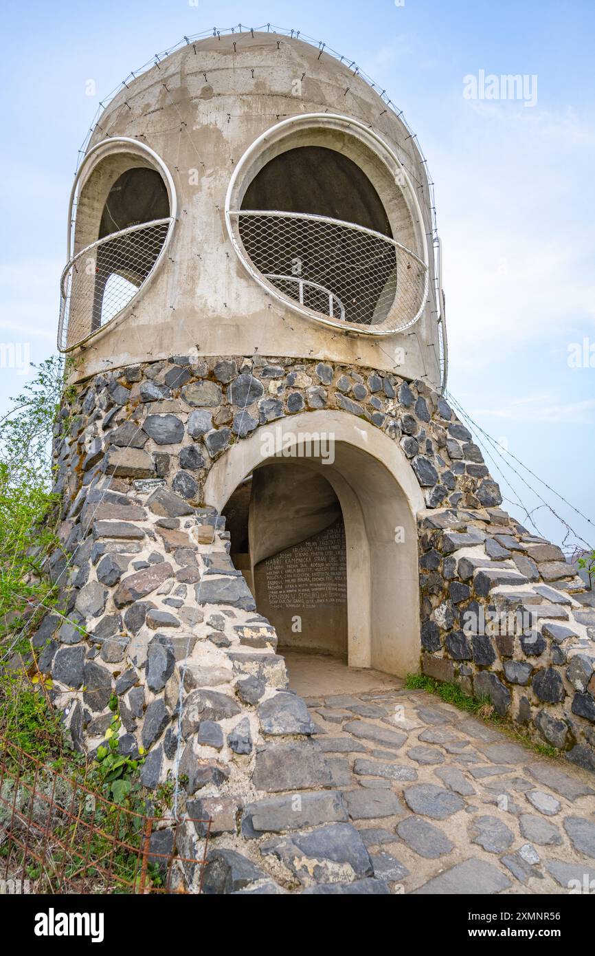A unique modern concrete lookout tower with large circular windows ...