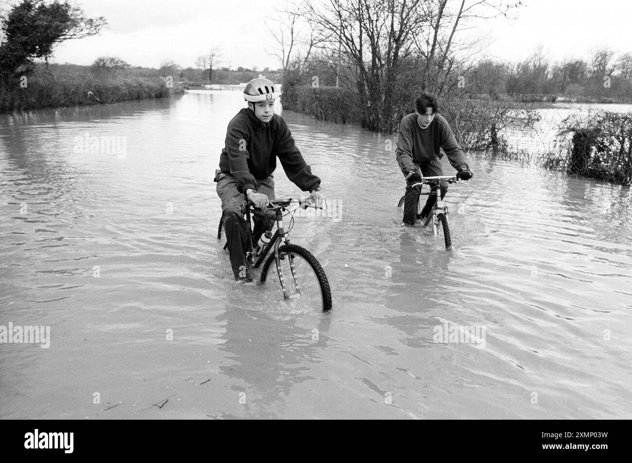 FloodsBoys on bicycles cycling through the floods 11 January 1994 Stock ...