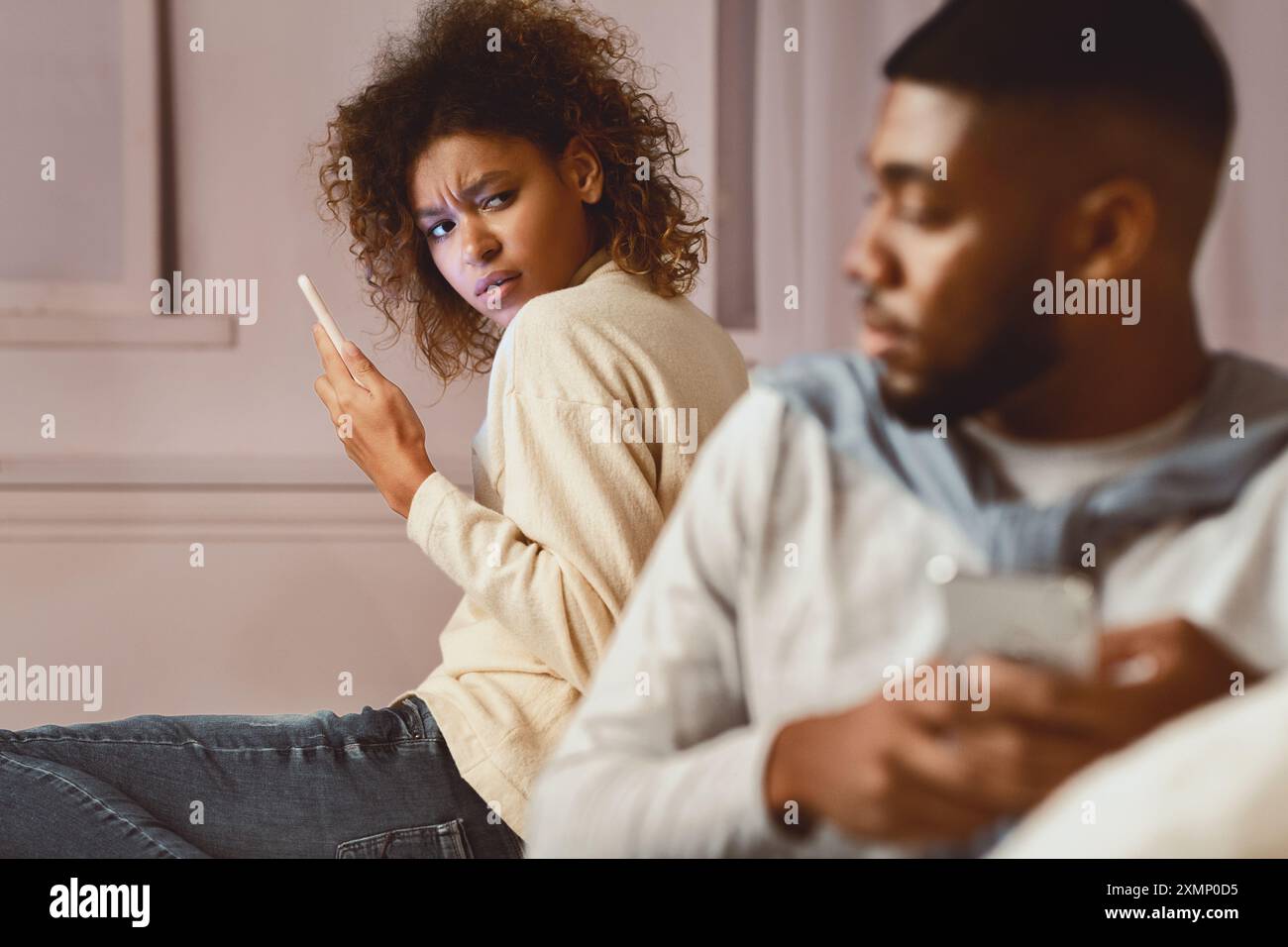 Afro woman suspecting husband in betrayal, looking at man Stock Photo ...