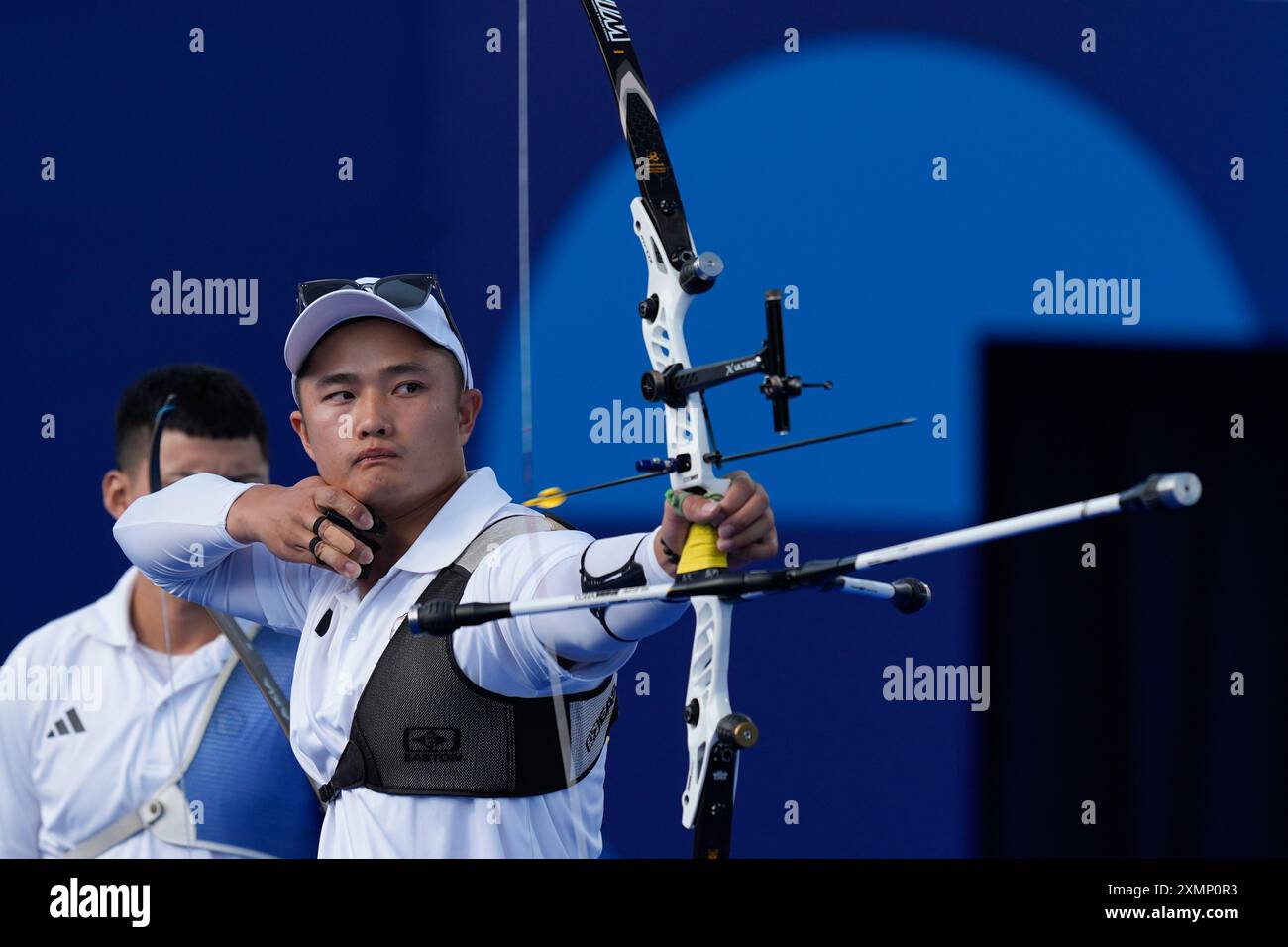 Taiwan's Tai Yu-Hsuan releases his arrow in the men's team archery ...