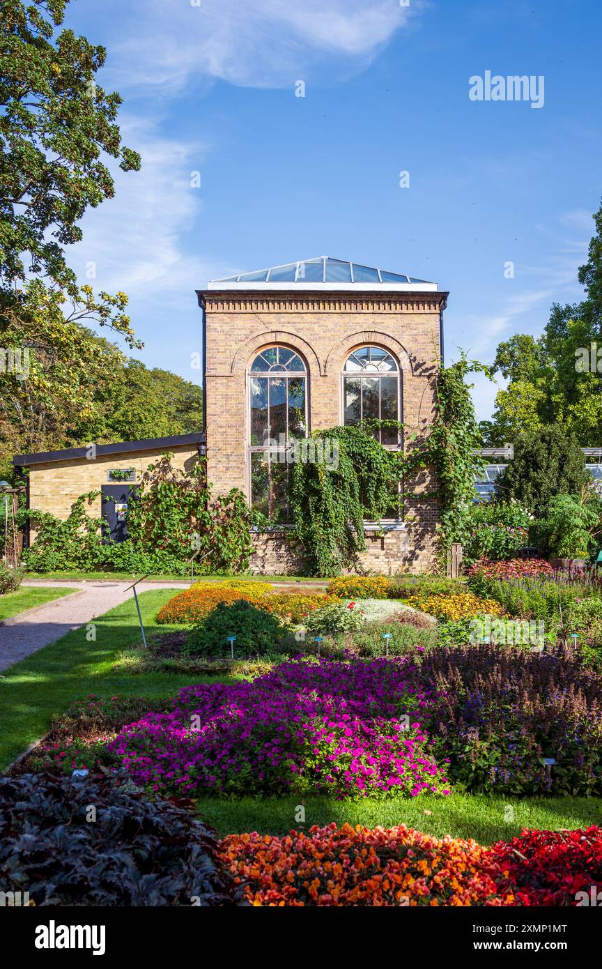 The historic garden house surrounded by colorful flowers in the ...