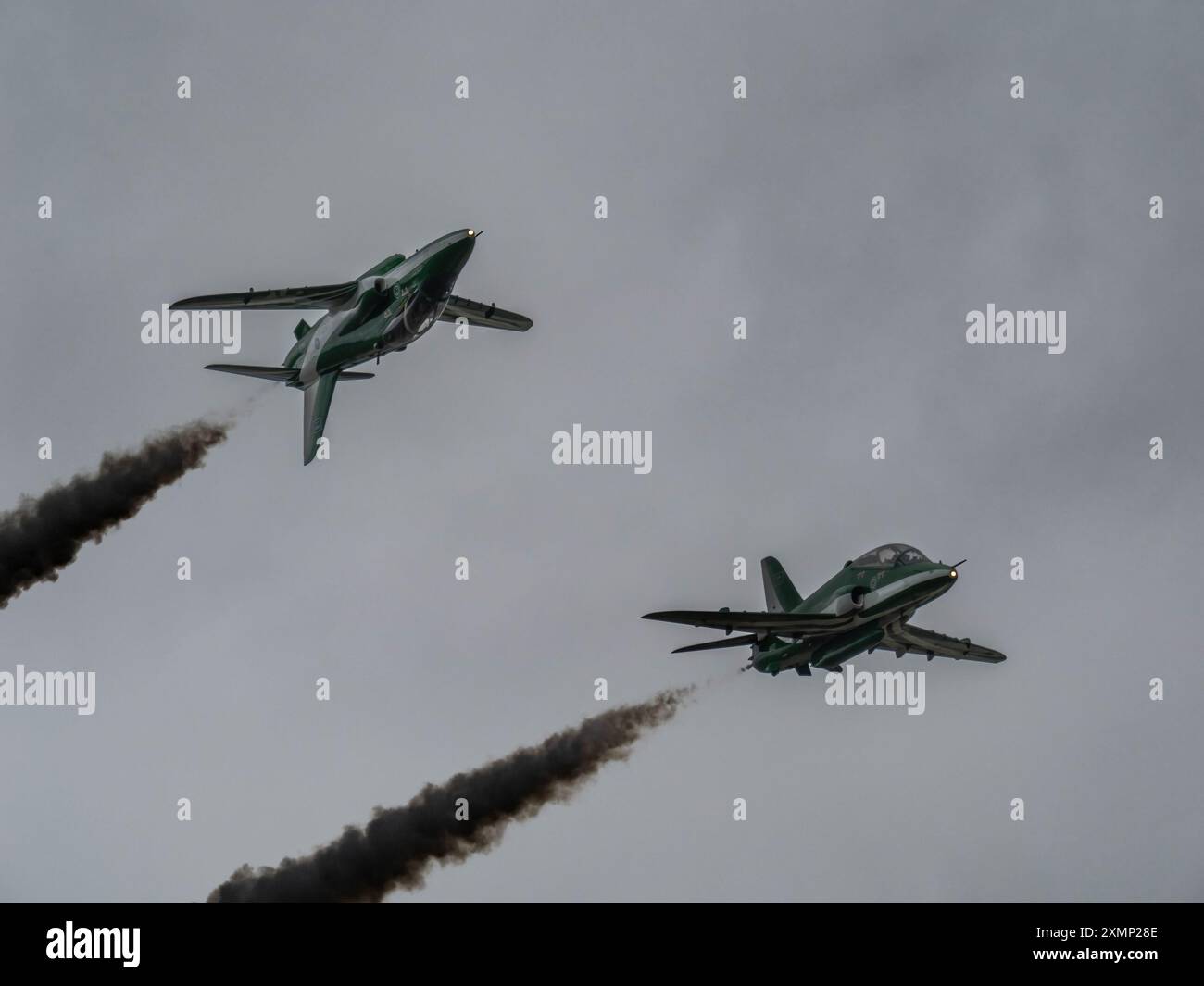 Two aircraft from the Saudi Hawks display team perform a crossing ...