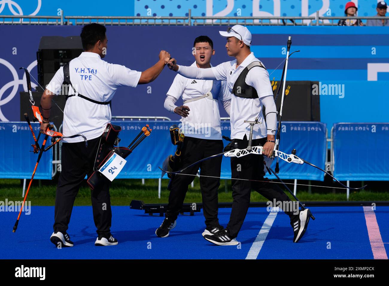 Taiwan's Tang Chih-Chun, right, Lin Zih-Siang, center, and Tai Yu-Hsuan celebrate during the men ...