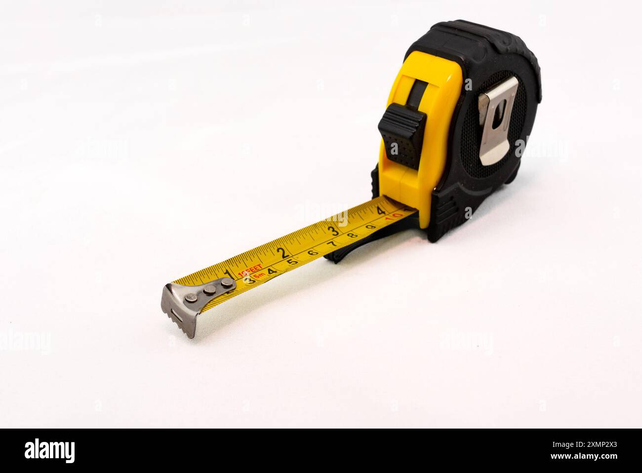 A close-up photo of a retractable tape measure, focusing on the details ...