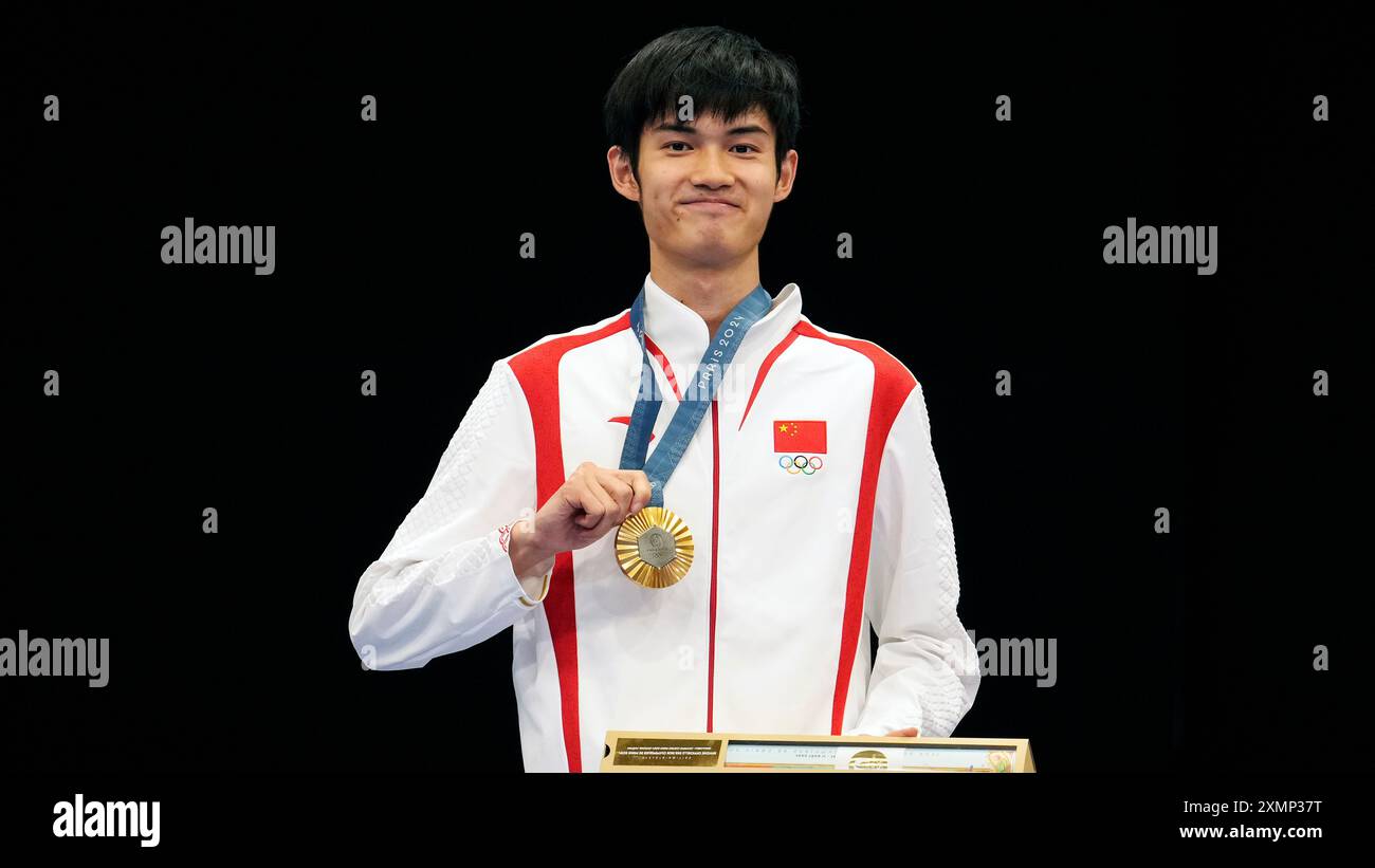 China's Sheng Lihao celebrates after winning the gold medal in the 10m ...
