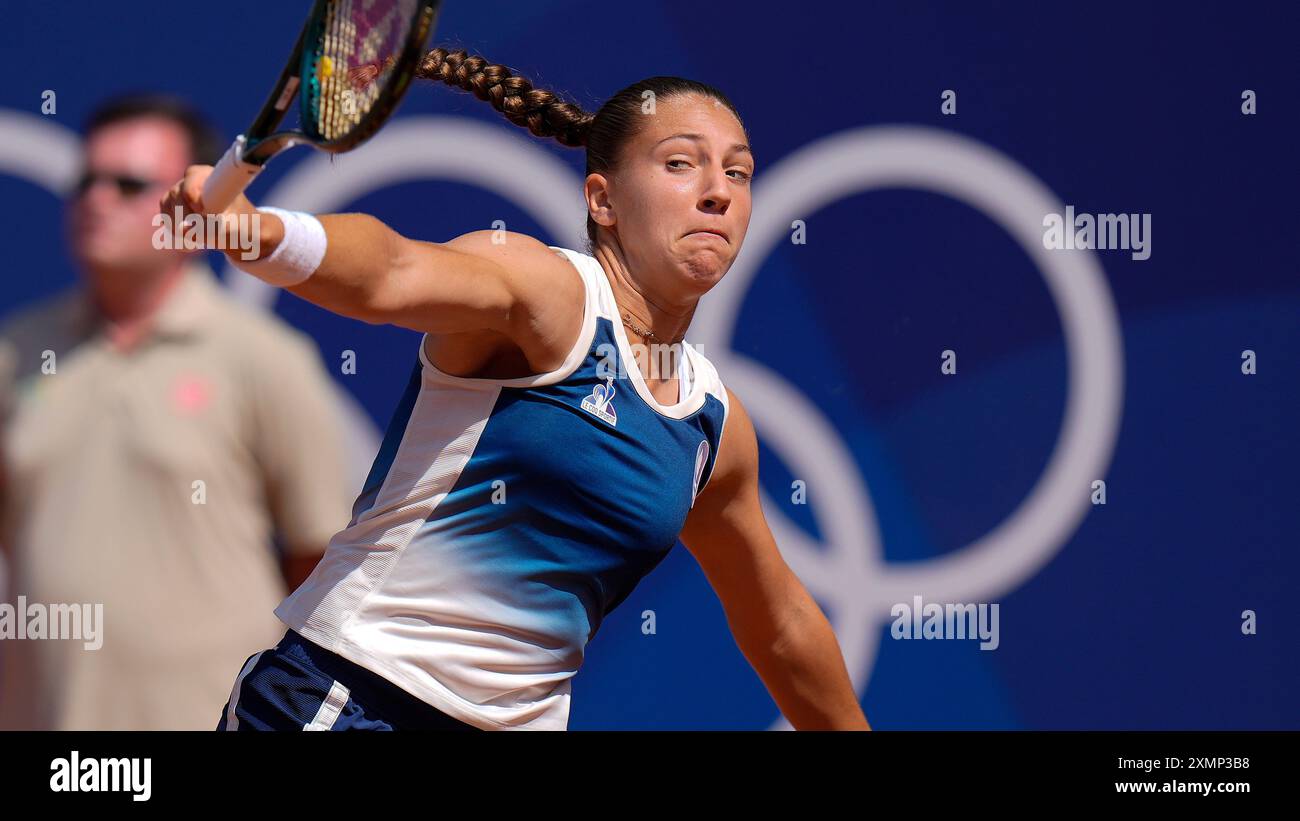 Diane Parry of France hits a backhand shot to Iga Swiatek of Poland ...