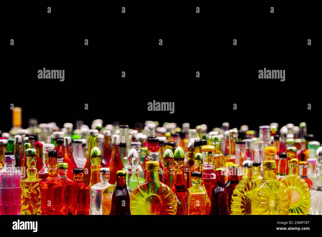various miniature bottles of alcohol without labels with black ...