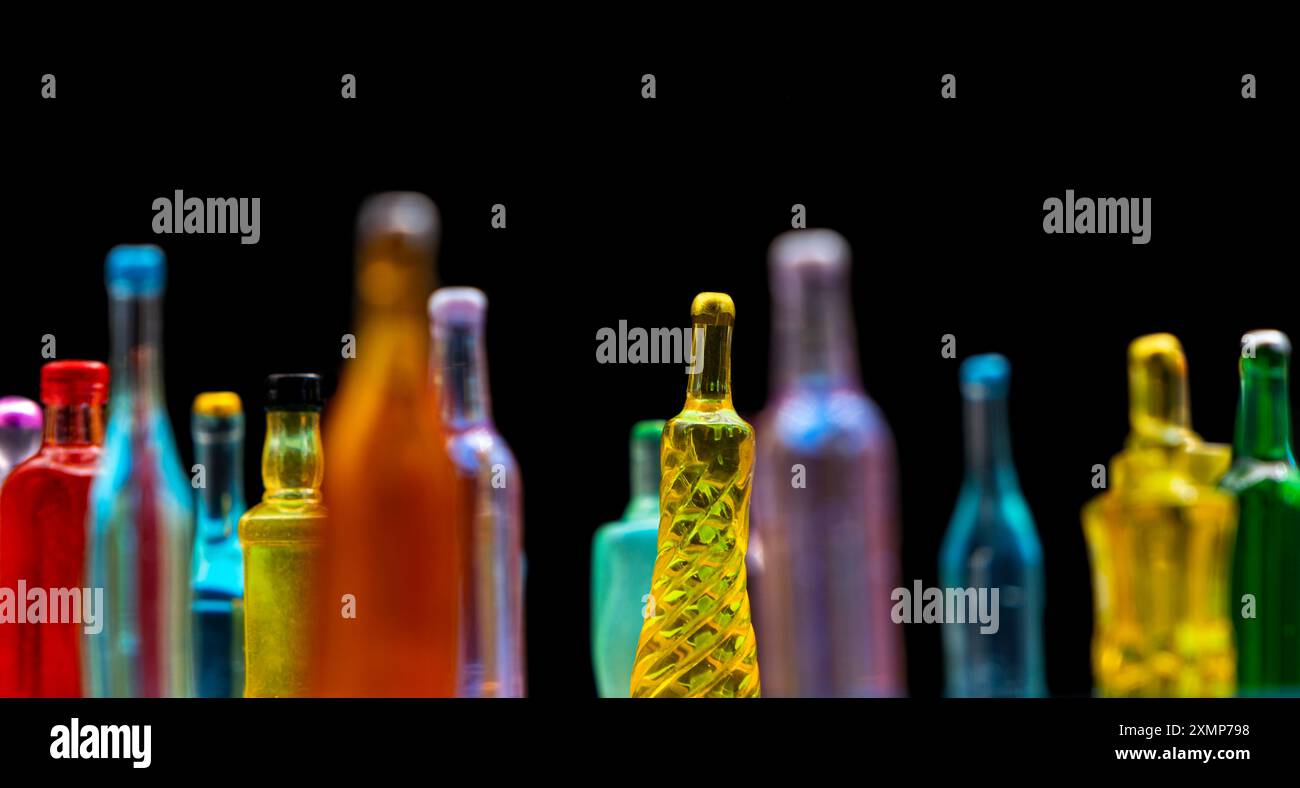 various miniature bottles of alcohol without labels with black ...