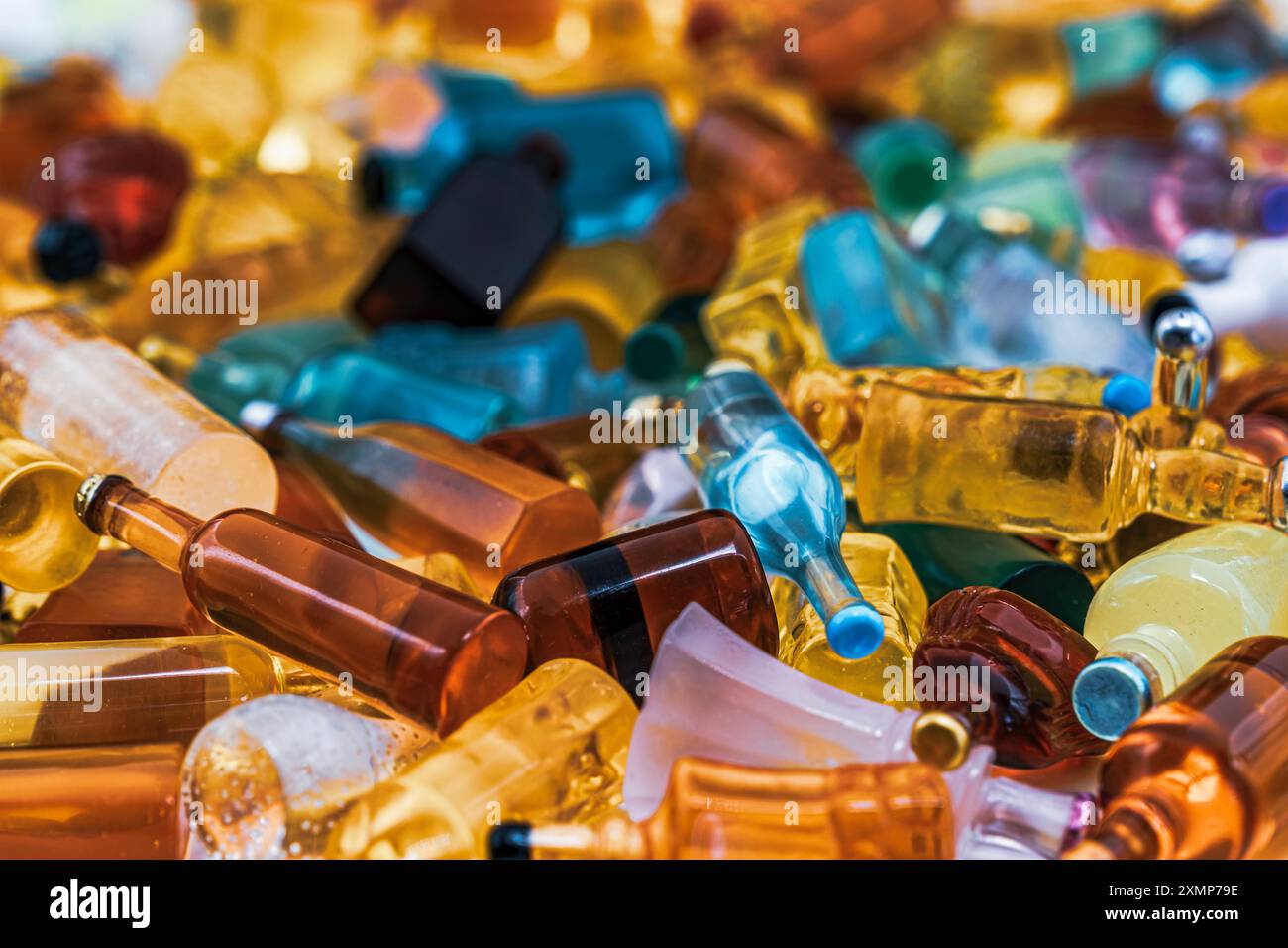 various miniature bottles of alcohol without labels with black ...