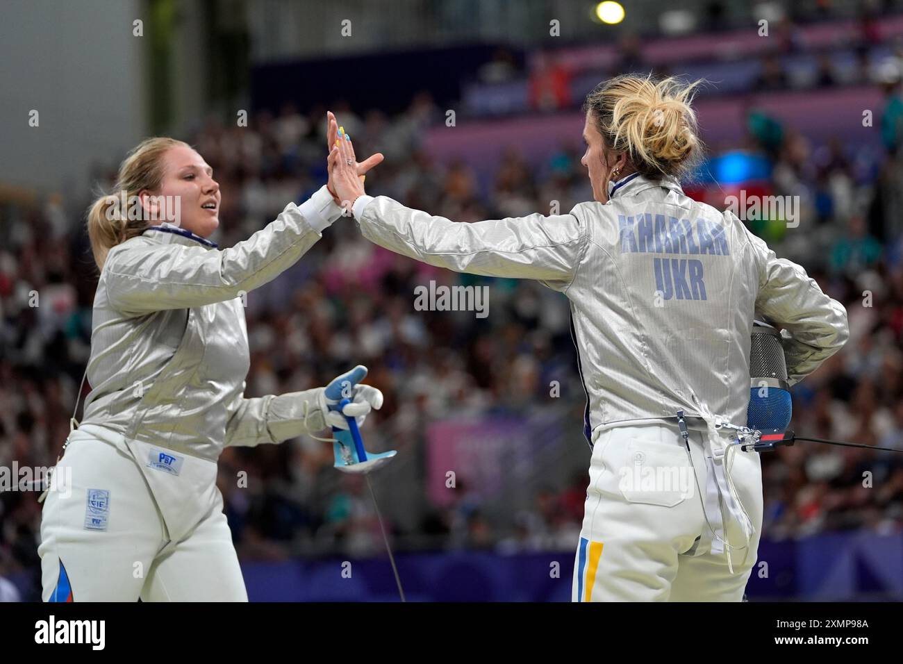 Ukraine's Olga Kharlan, right, celebrates with Azerbaijan's Anna Bashta ...