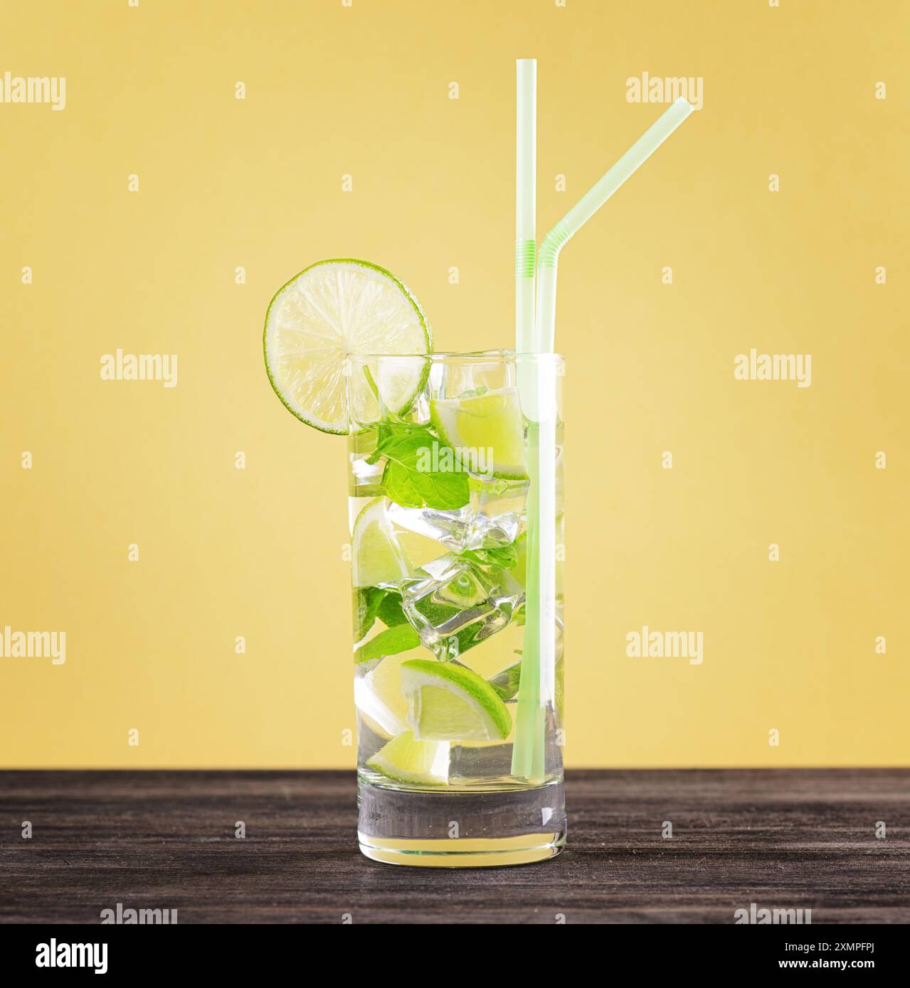 Glass of mojito cocktail on pastel yellow background Stock Photo - Alamy