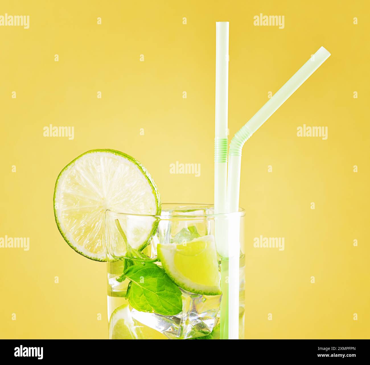 Glass of mojito cocktail on pastel yellow background Stock Photo - Alamy