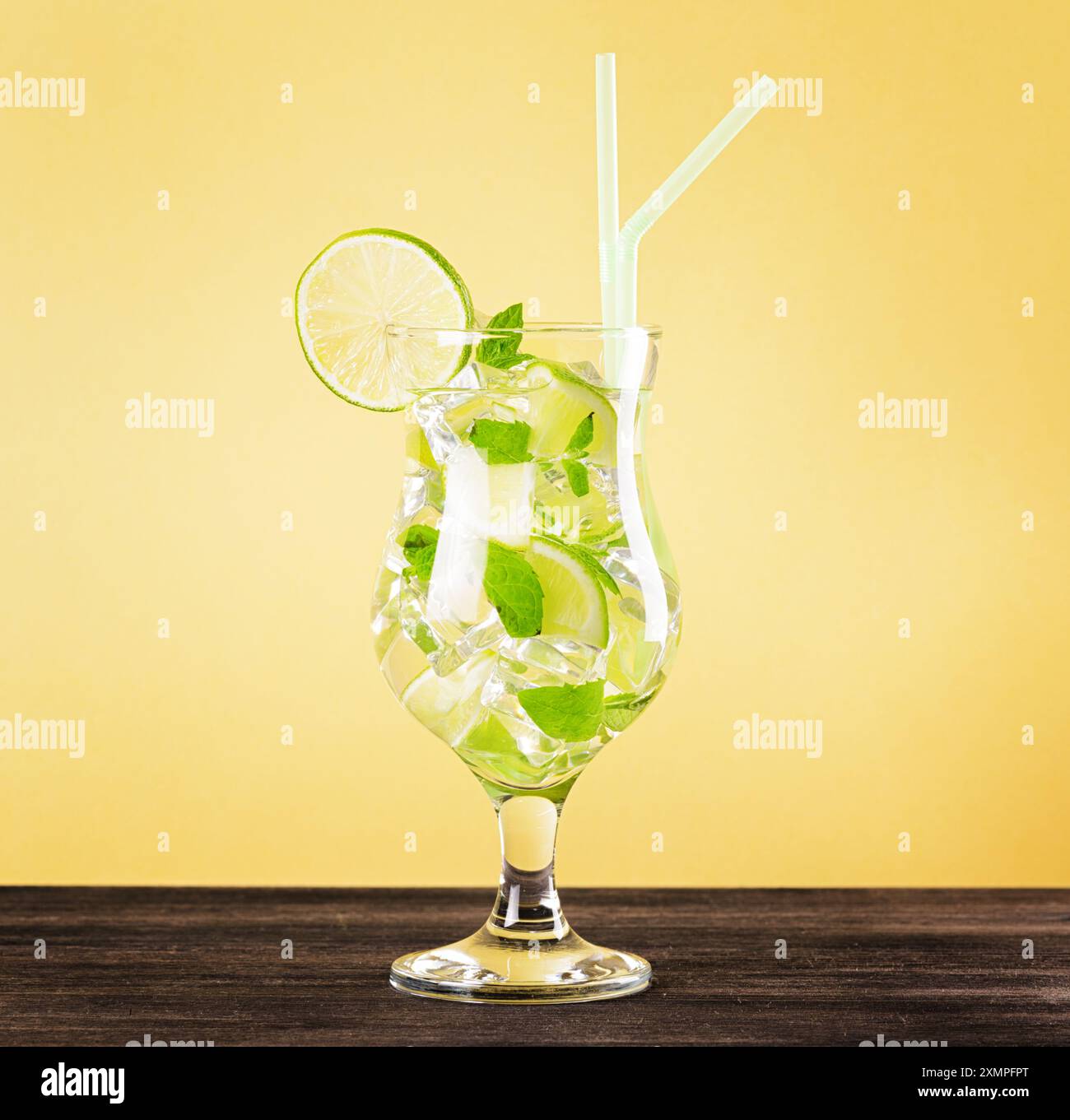 Glass of mojito cocktail on pastel yellow background Stock Photo - Alamy