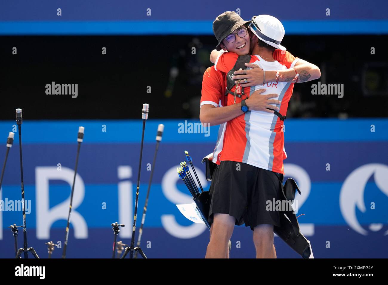 Turkey's Mete Gazoz hugs Turkey's Berkim Tumer during the men's team ...