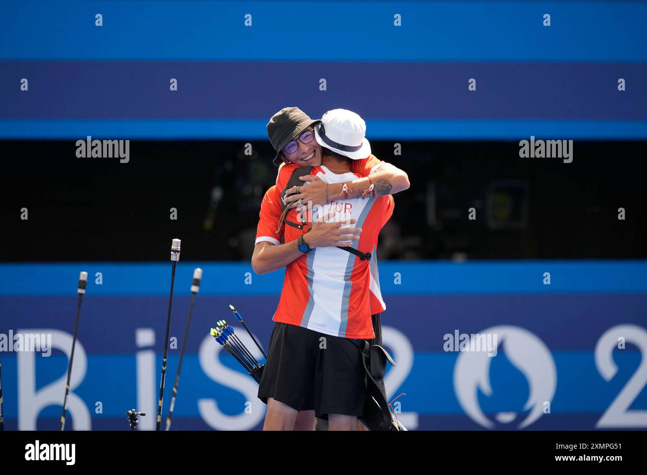 Turkey's Mete Gazoz hugs Turkey's Berkim Tumer during the men's team ...