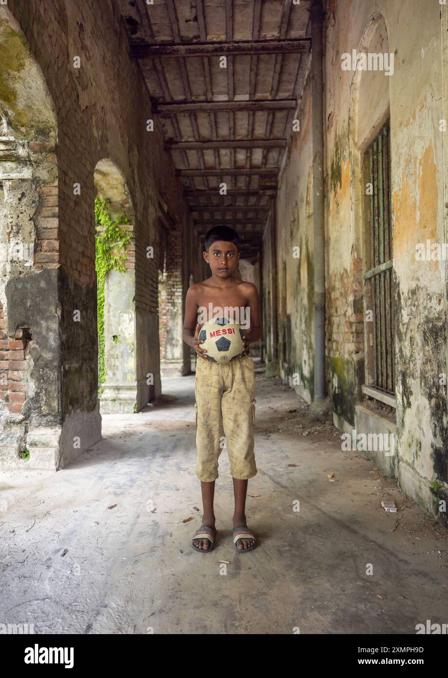 Bangladeshi boy with a Messi ball in Pakutia Zamindar Bari, Dhaka ...