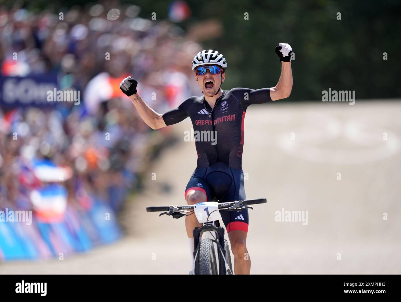 Great Britain's Tom Pidcock crosses the line to win gold during the Men ...
