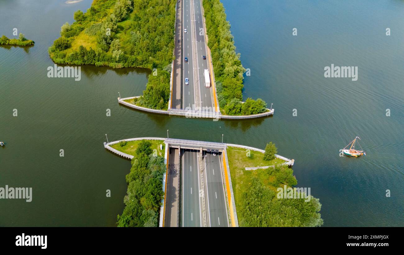 Showing a highway bridge under a canal with sailing boats hi-res stock ...