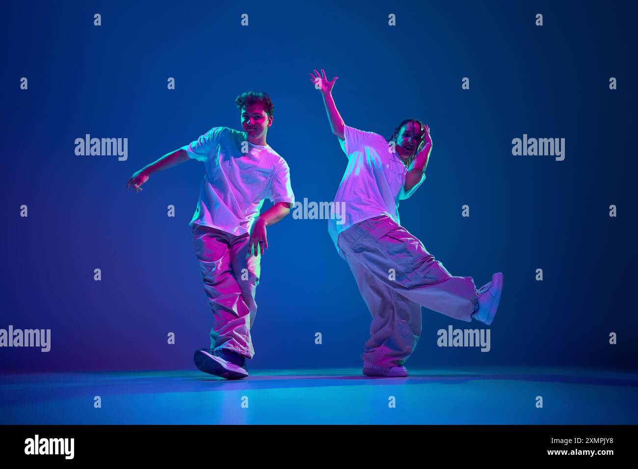 Flexible and energetic young people, man and woman dancing hip-hop ...