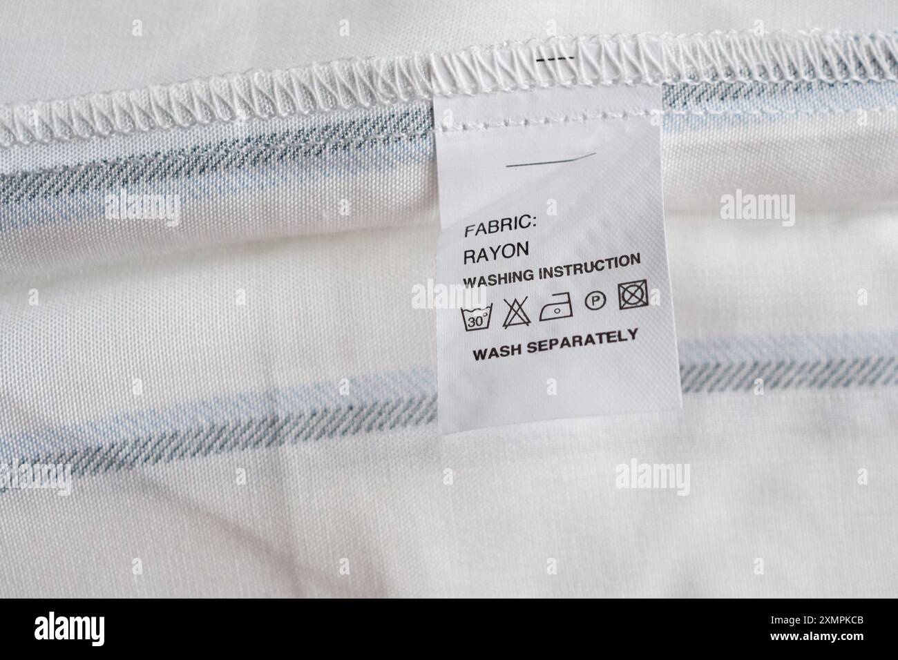 White laundry care washing instructions clothes label on rayon shirt ...