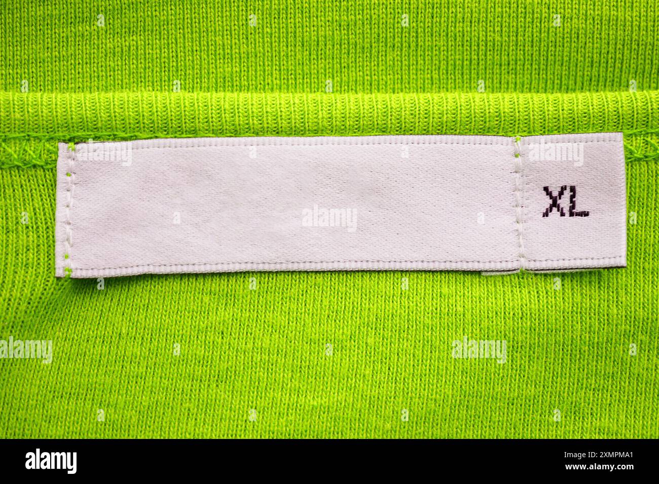 Blank white clothes tag label with XL size on new green shirt Stock ...