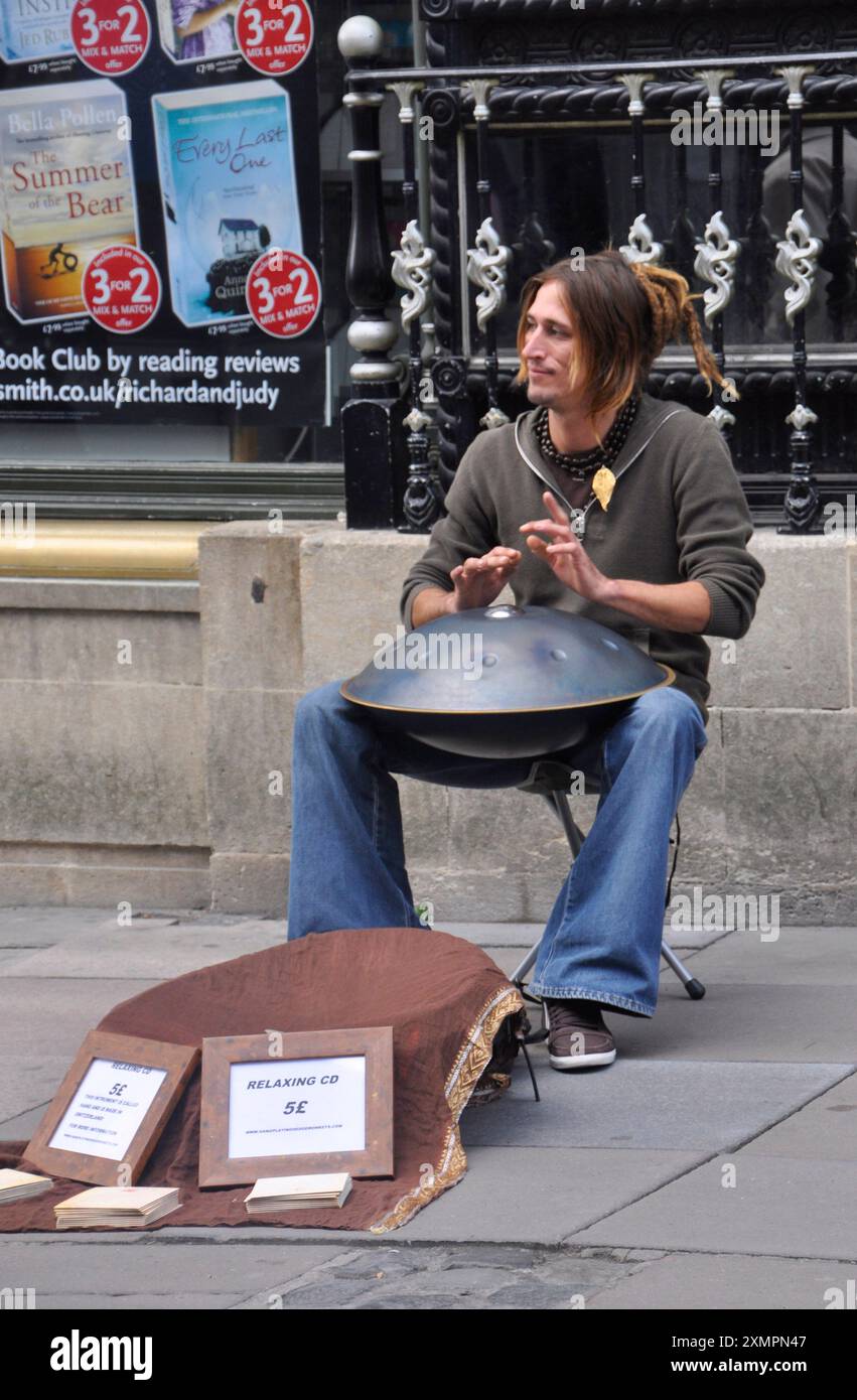A busker in Bath is playing a Hang musical instrument which was ...
