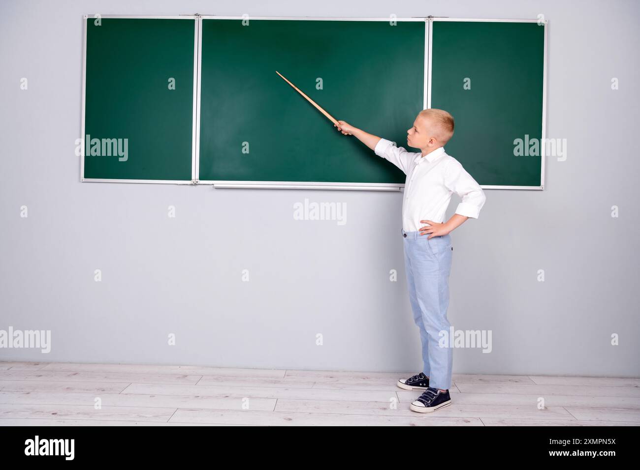 Photo of charming cute nice boy schoolkid standing in class room ...