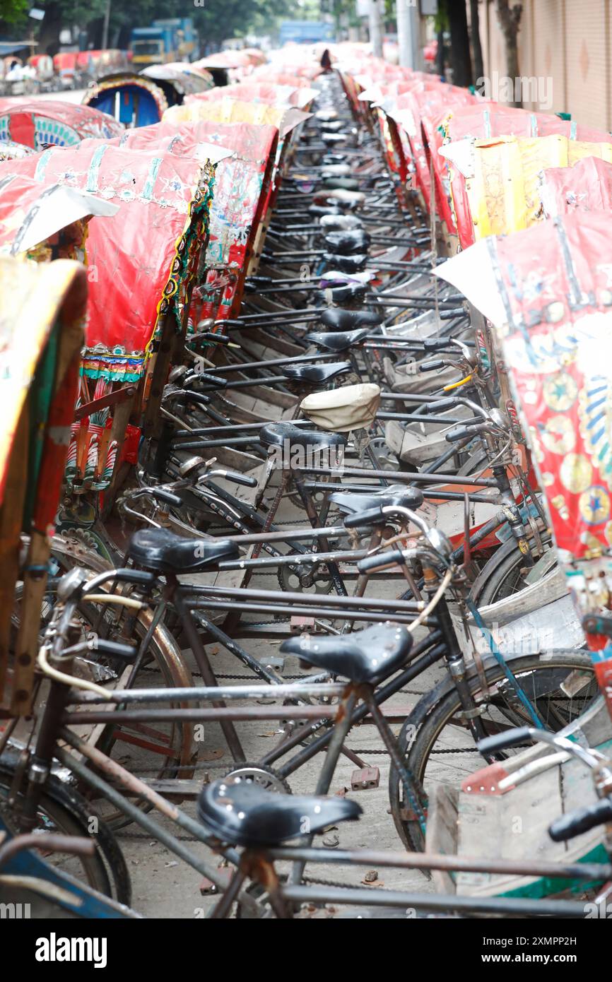 Dhaka, Bangladesh - July 20, 2024: Rows of rickshaws have been parked ...